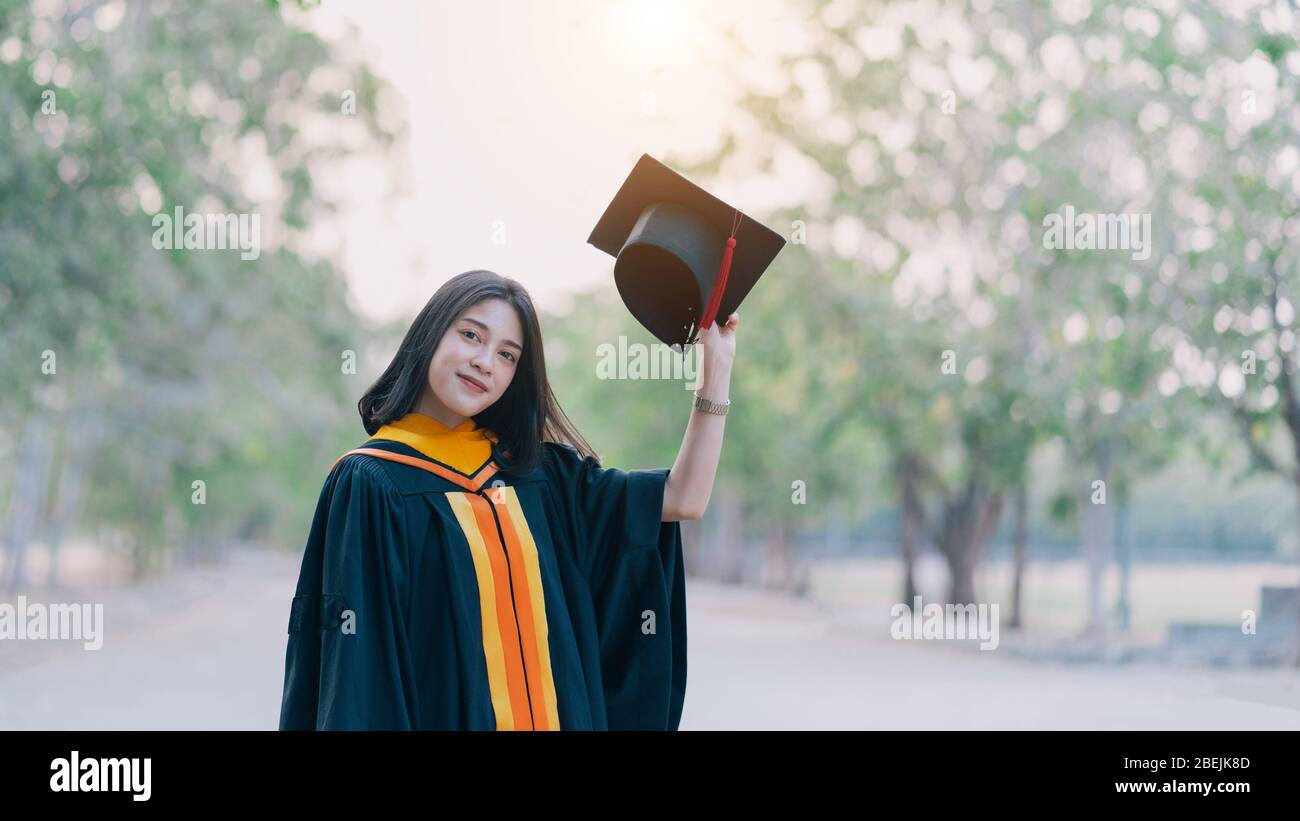 Young charming Asian feemale gradutes cerebrate her degree graduation ...