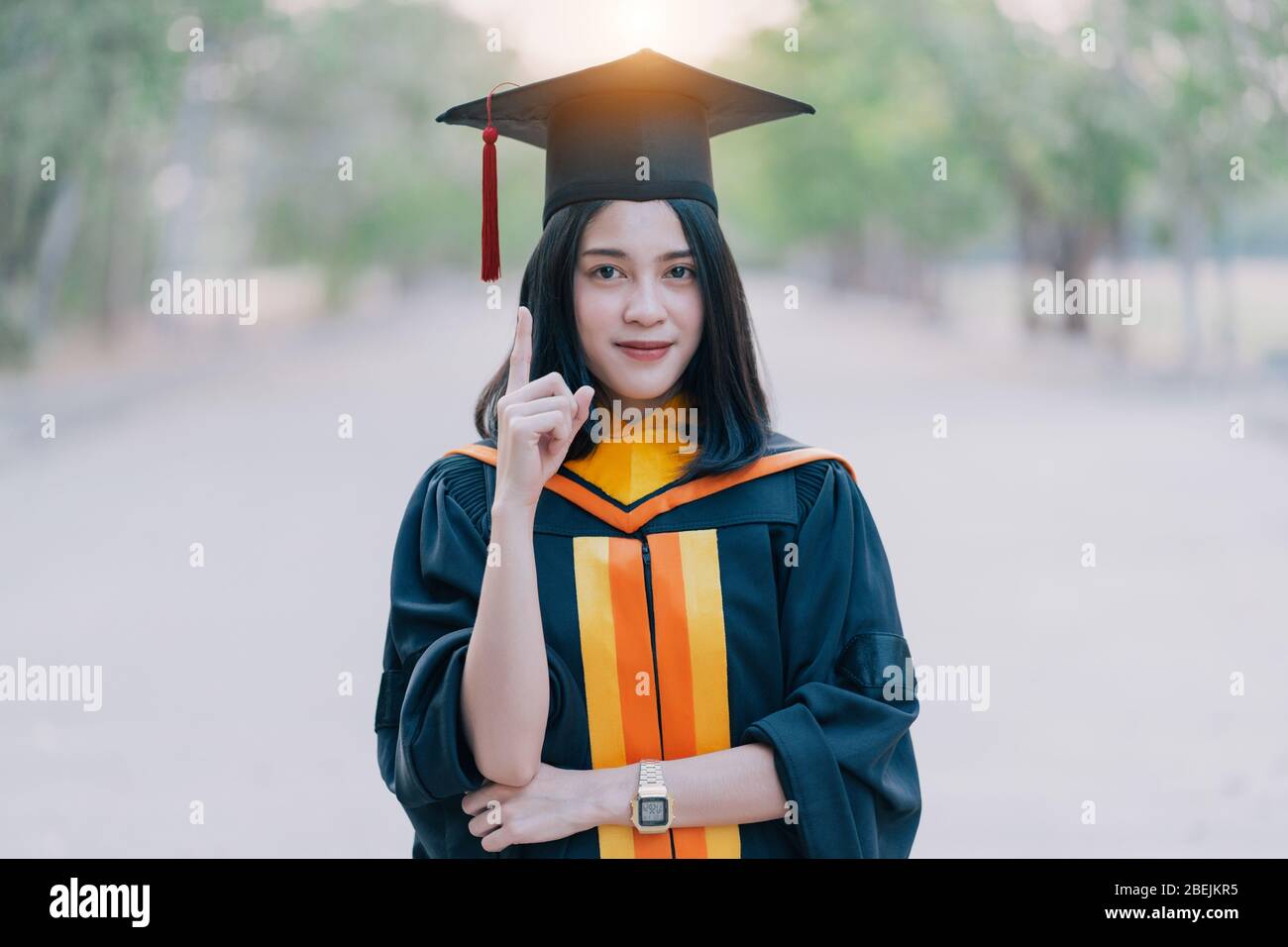 Young charming Asian feemale gradutes cerebrate her degree graduation ...