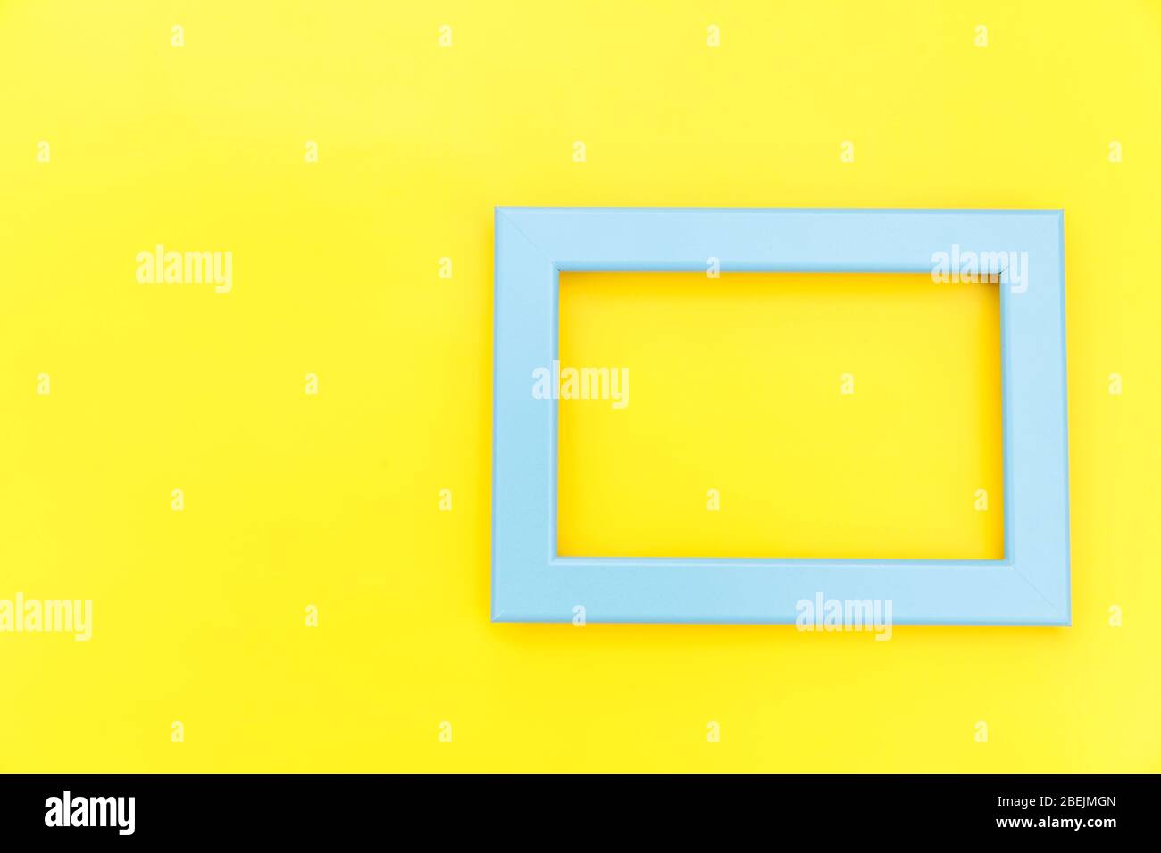 Simply design with empty blue frame isolated on yellow colourful trendy ...