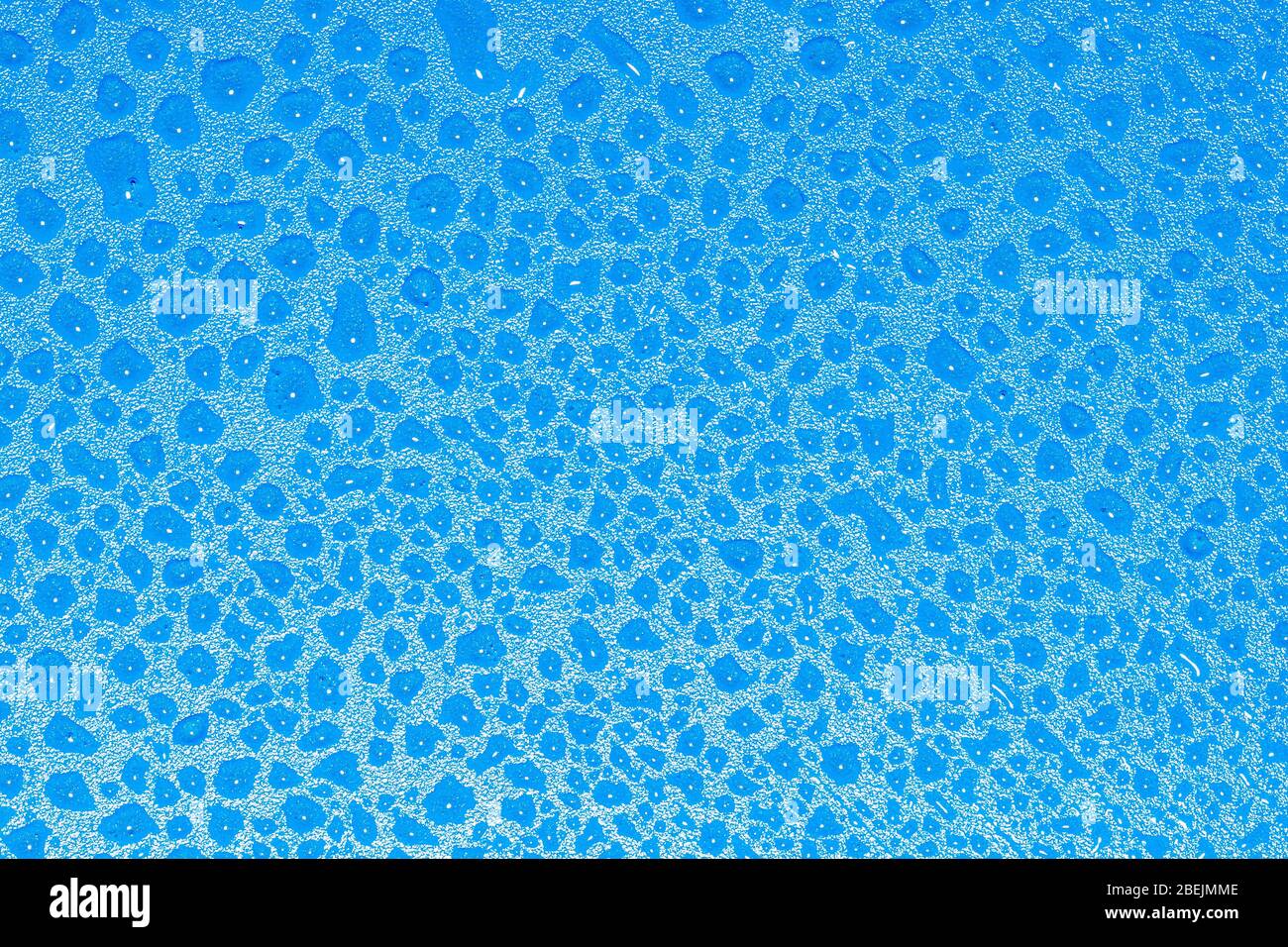 Macro water drops texture on a blue backdrop. Abstract pattern or blank ...