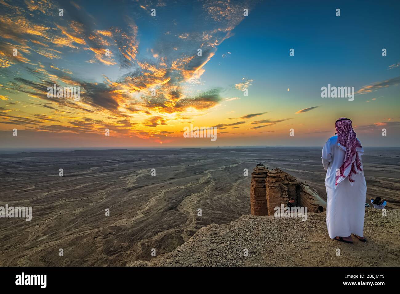 An arab man standing in Edge of the world, a natural landmark and ...