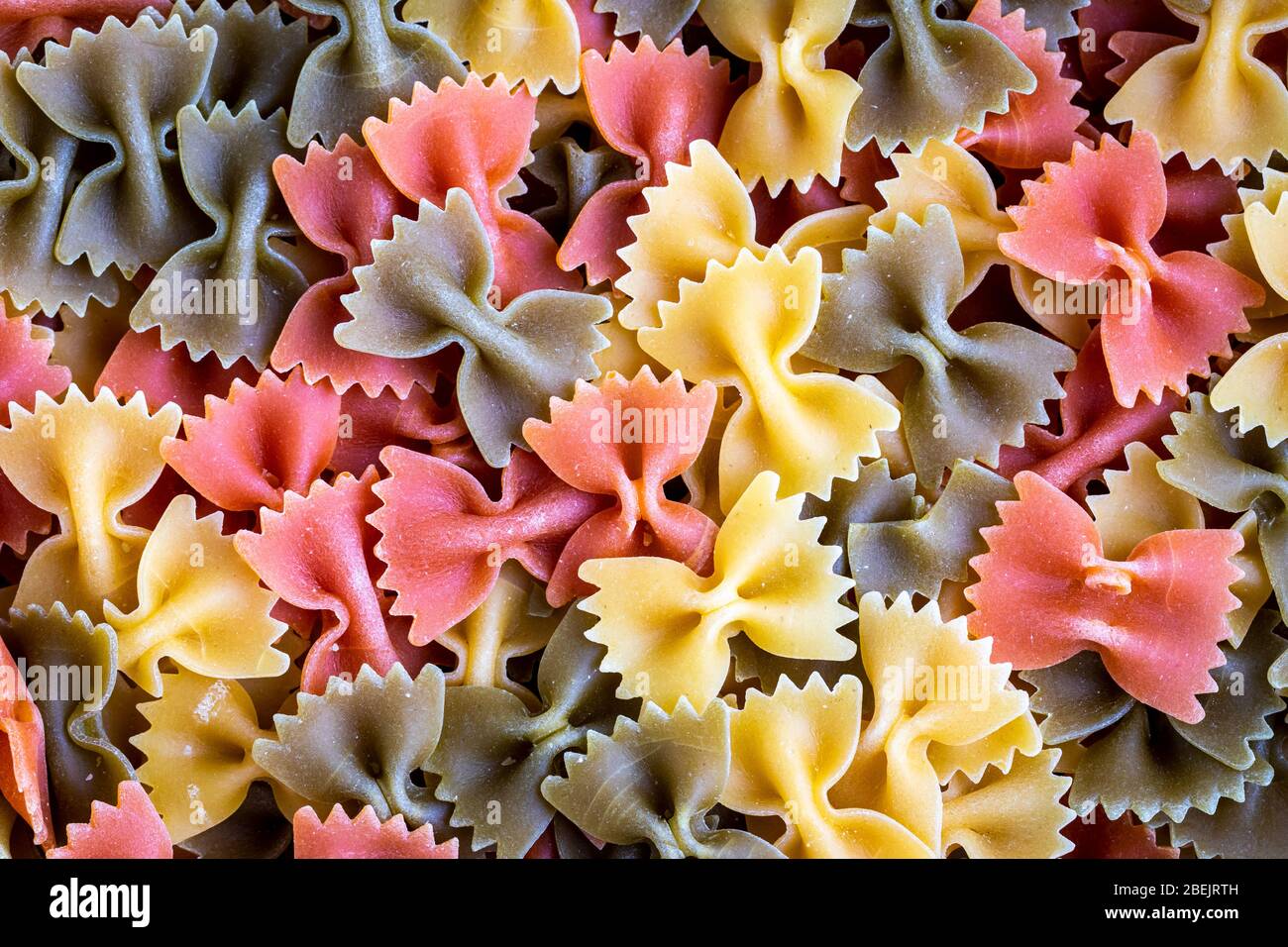 Colorful italian pasta farfalle tricolore abstract background ...