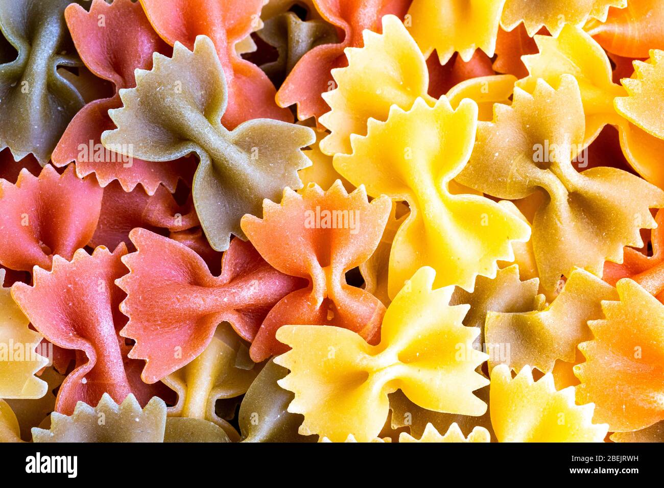 Colorful italian pasta farfalle tricolore abstract background ...