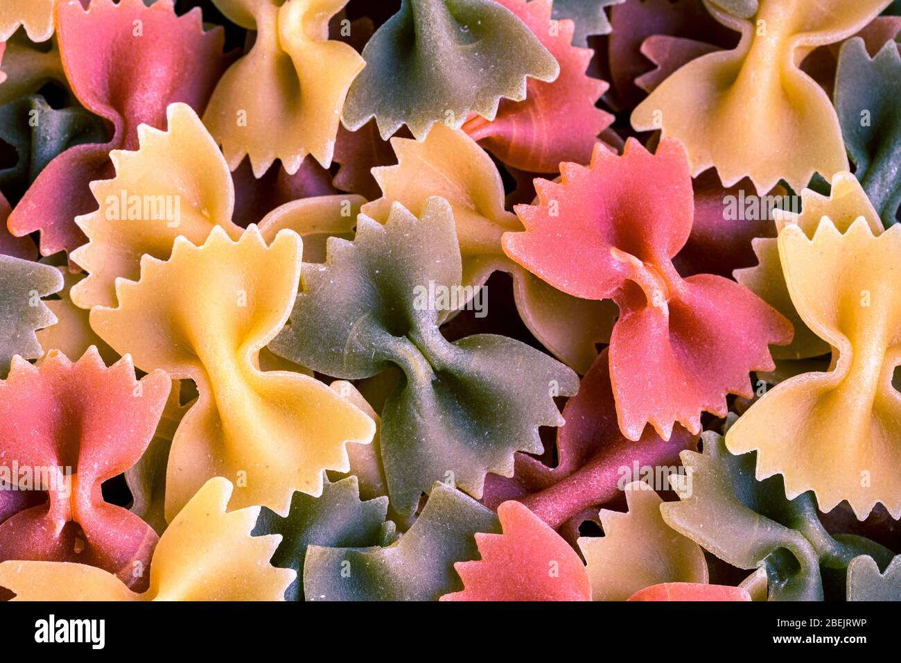 Colorful italian pasta farfalle tricolore abstract backdrop ...