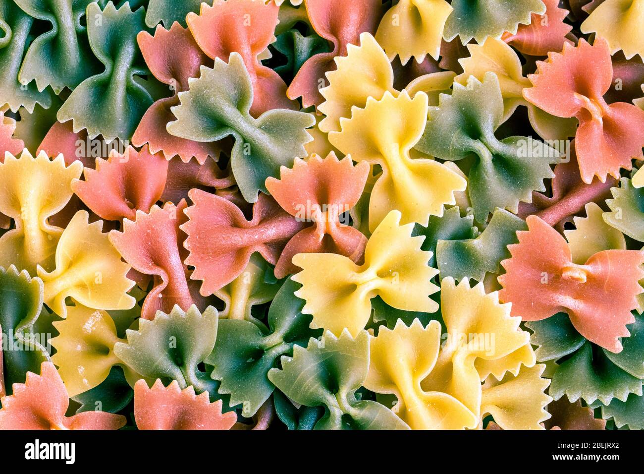 Colorful italian pasta farfalle tricolore abstract background ...