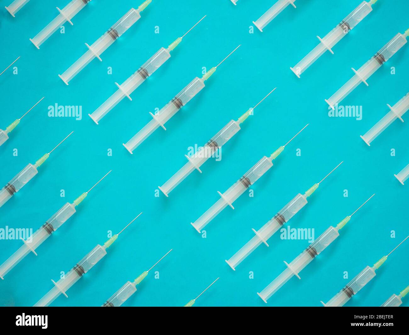 Syringe pattern on blue background Stock Photo - Alamy