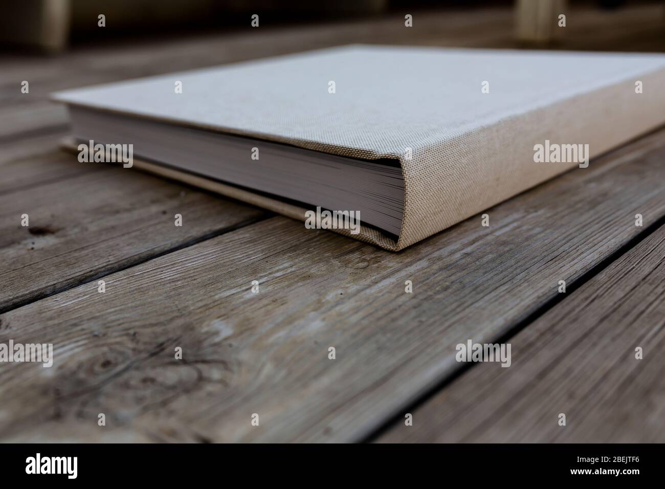 Wedding albums on beautiful wood background. Cloth cover without names ...