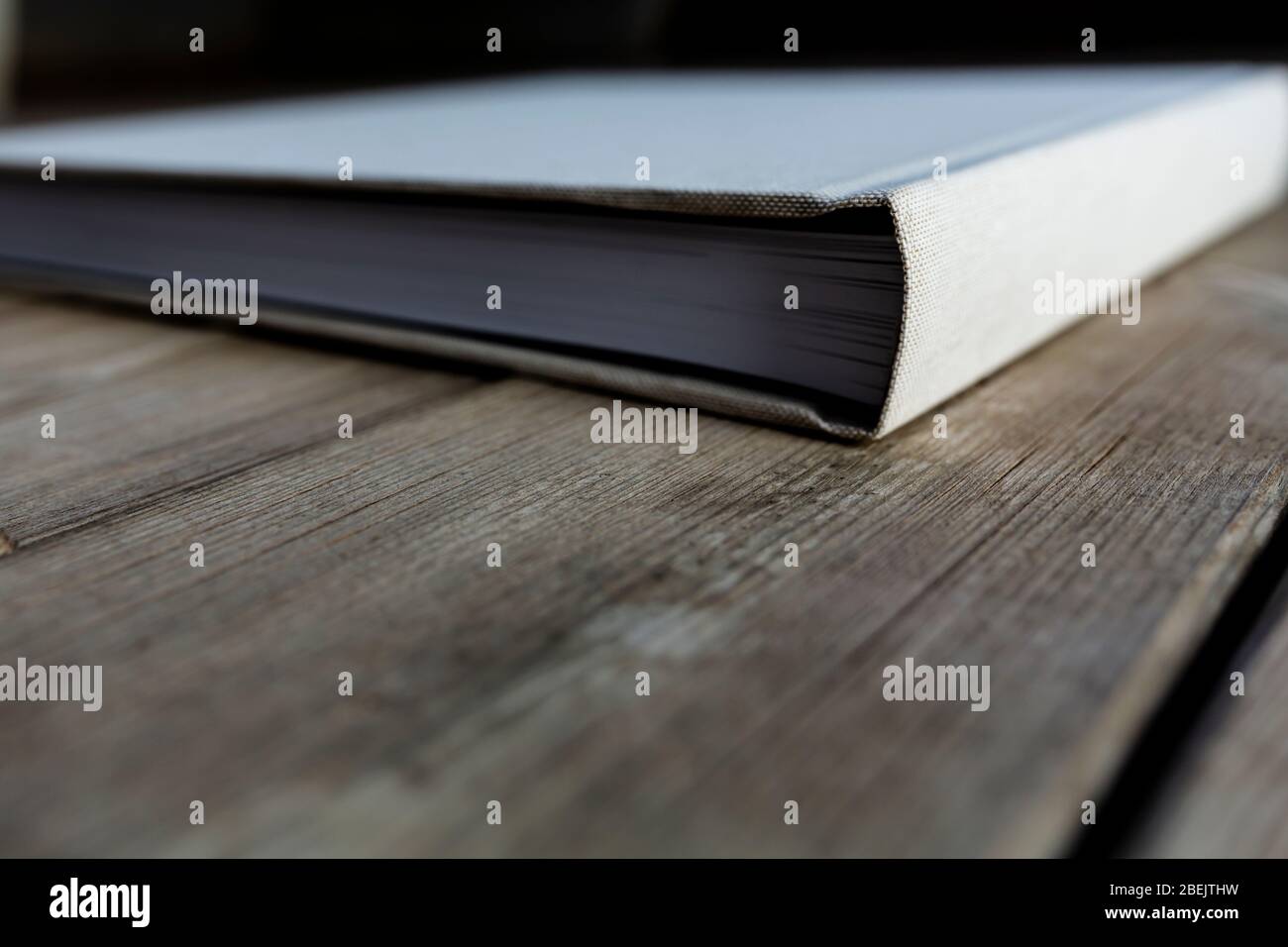 Wedding albums on beautiful wood background. Cloth cover without names ...