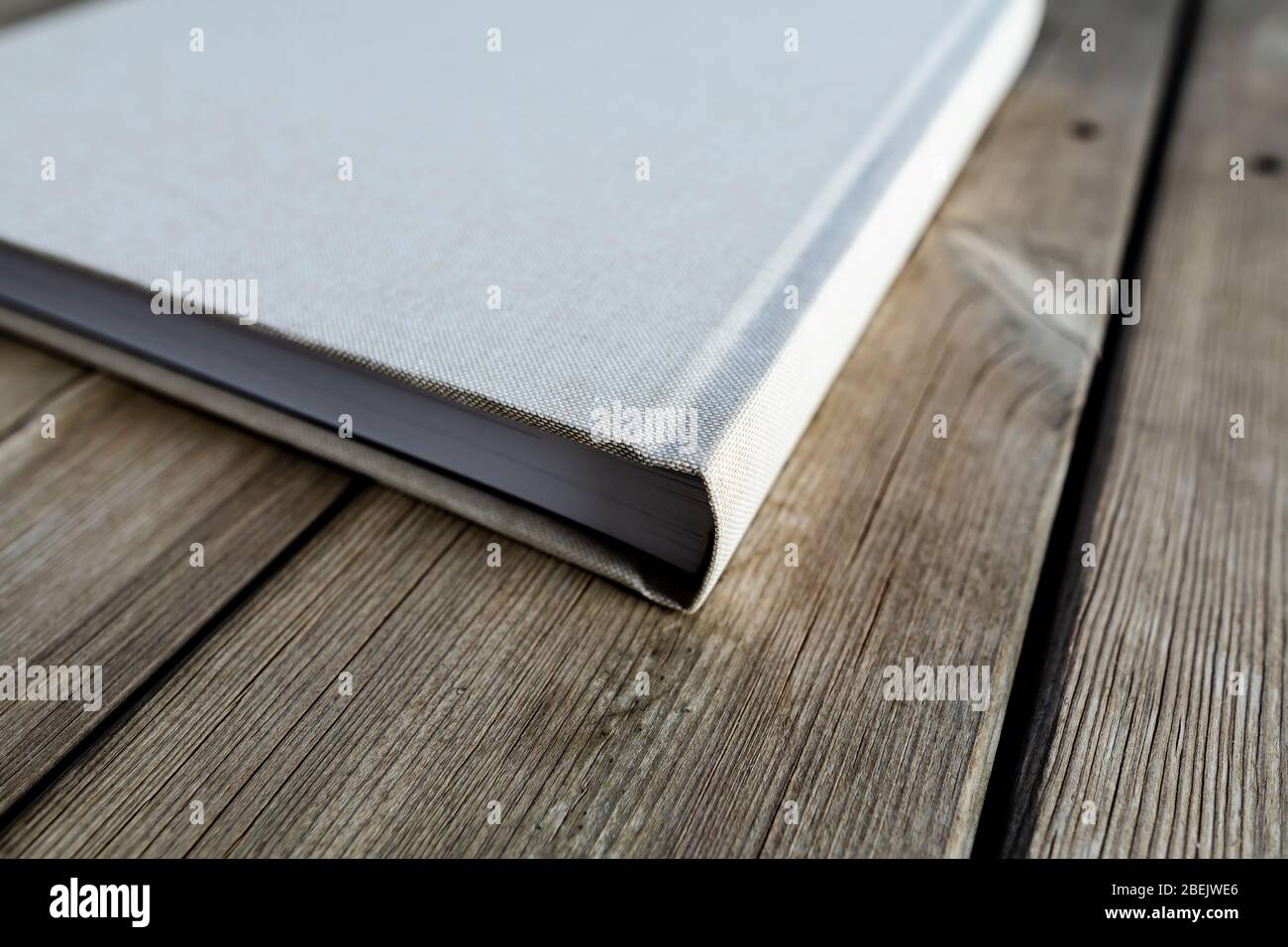 Wedding albums on beautiful wood background. Cloth cover without names ...