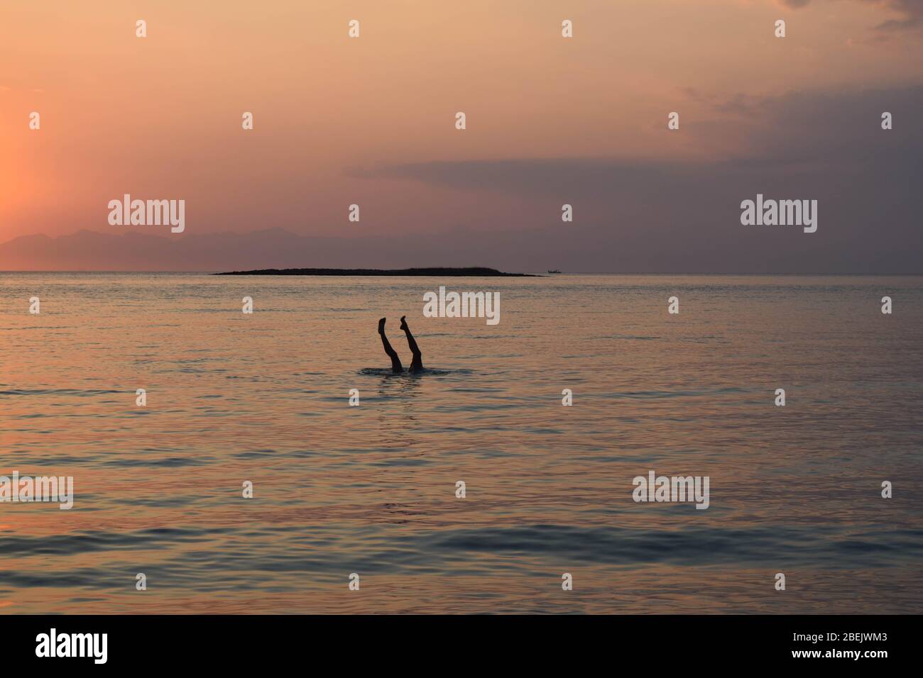 Two legs popping out of a pastel colored sea, Elafonisos, Greece Stock ...