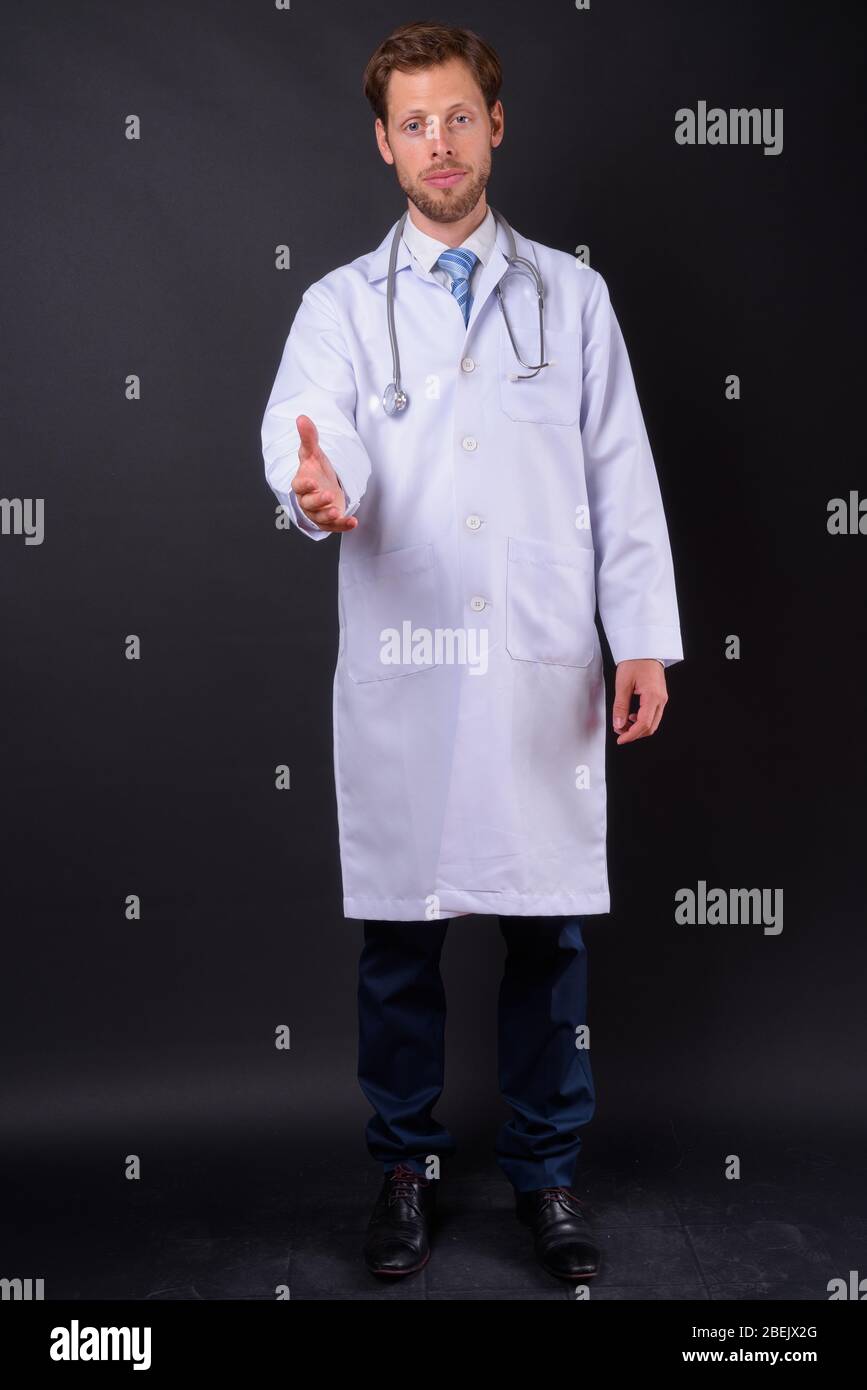 Full body shot of bearded man doctor giving handshake Stock Photo - Alamy