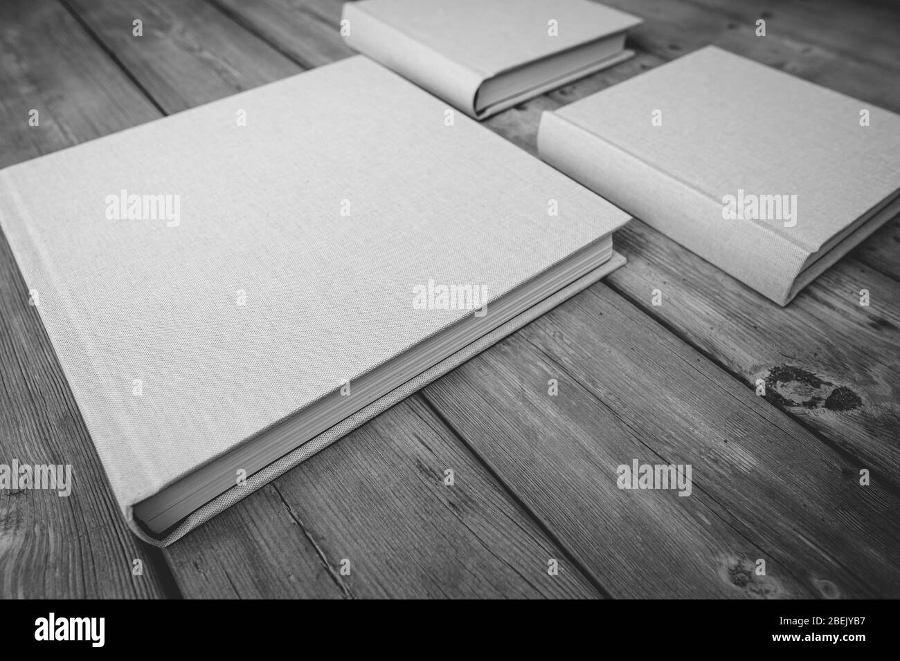 Wedding albums on beautiful wood background. Cloth cover without names ...