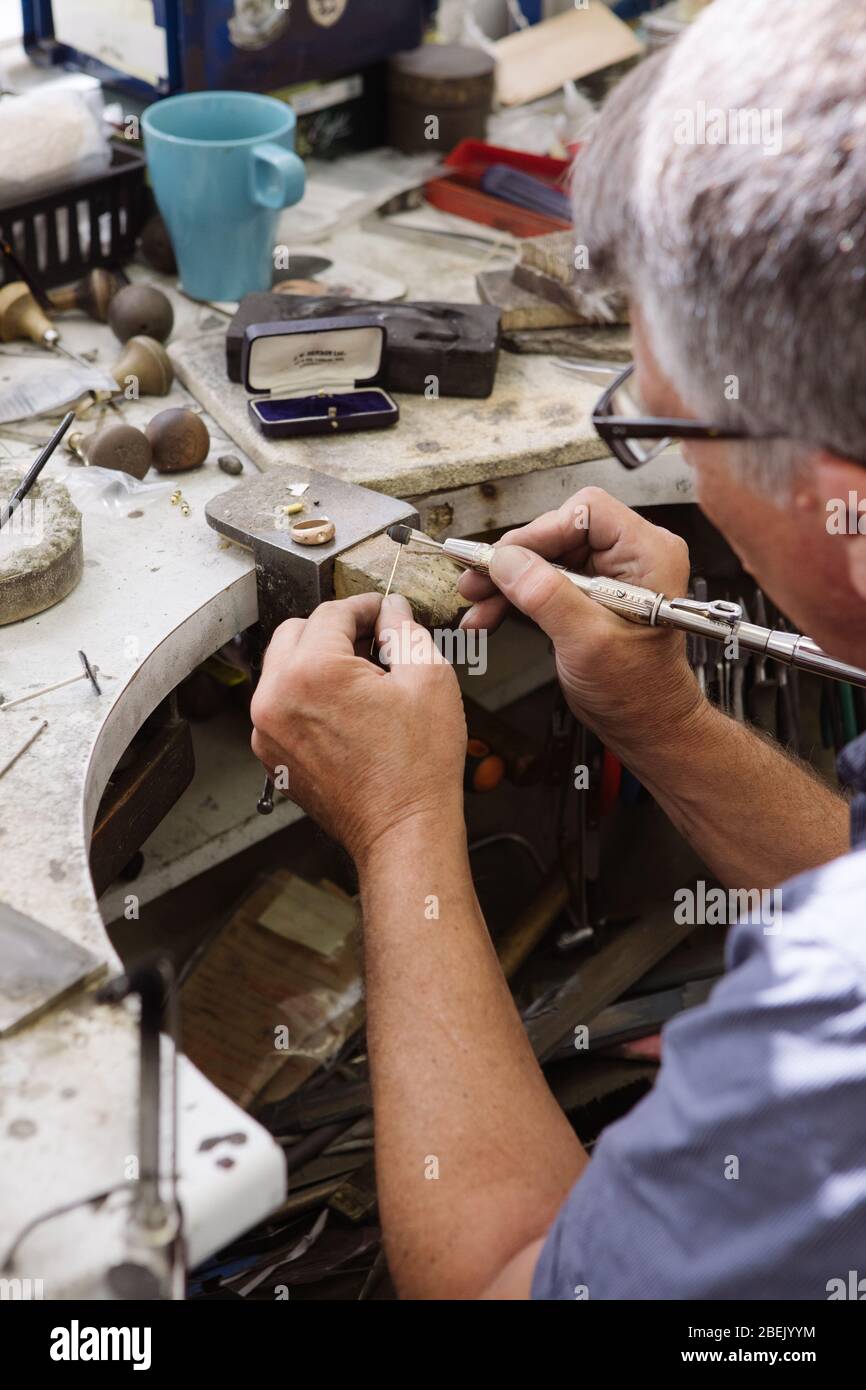 Jeweller working an a ring Stock Photo - Alamy