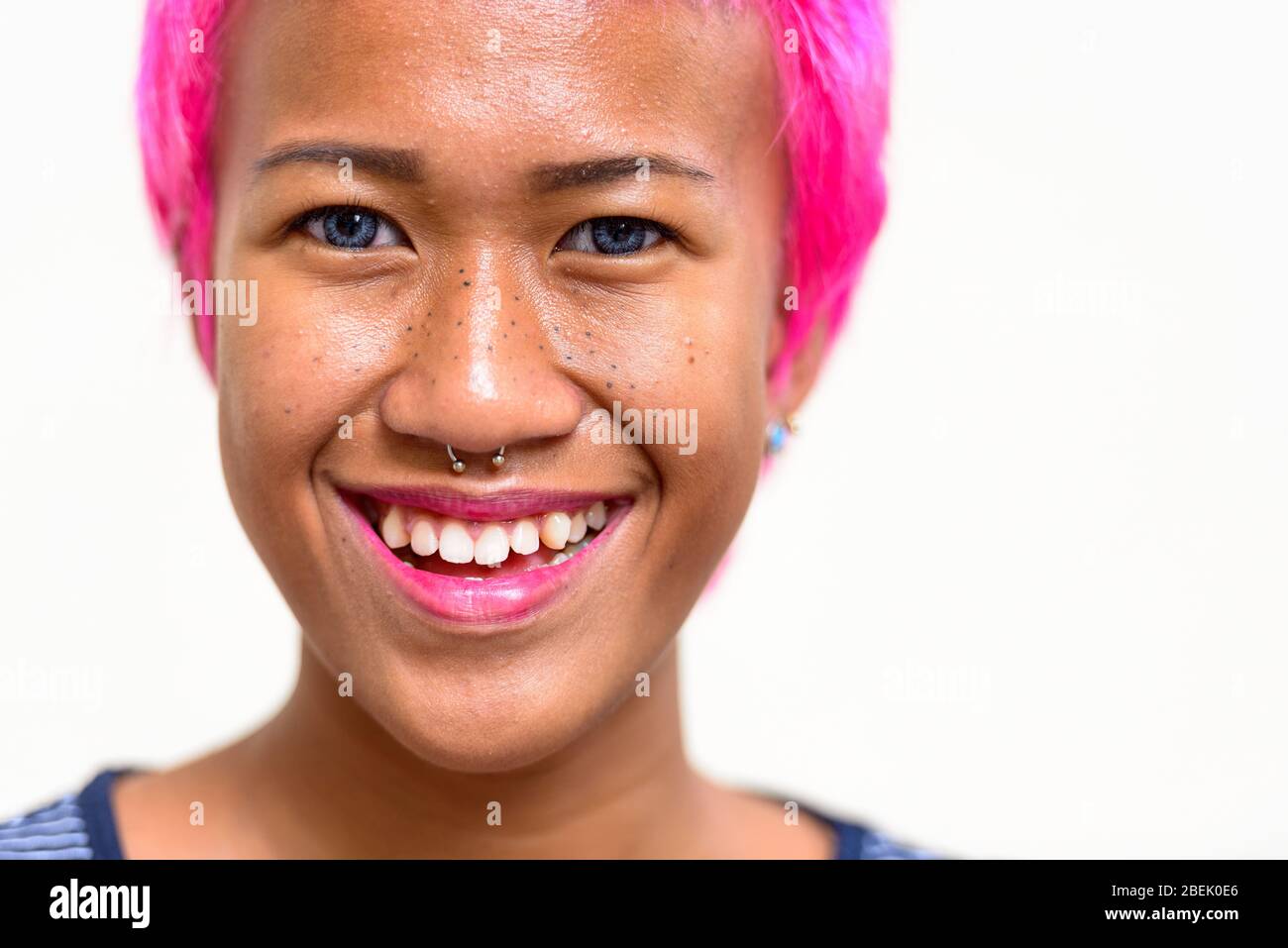 Face of happy young rebellious Asian woman with pink hair smiling Stock ...