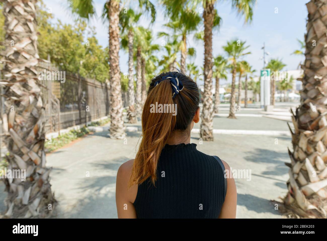 Rear view of young Asian tourist woman in the street Stock Photo - Alamy