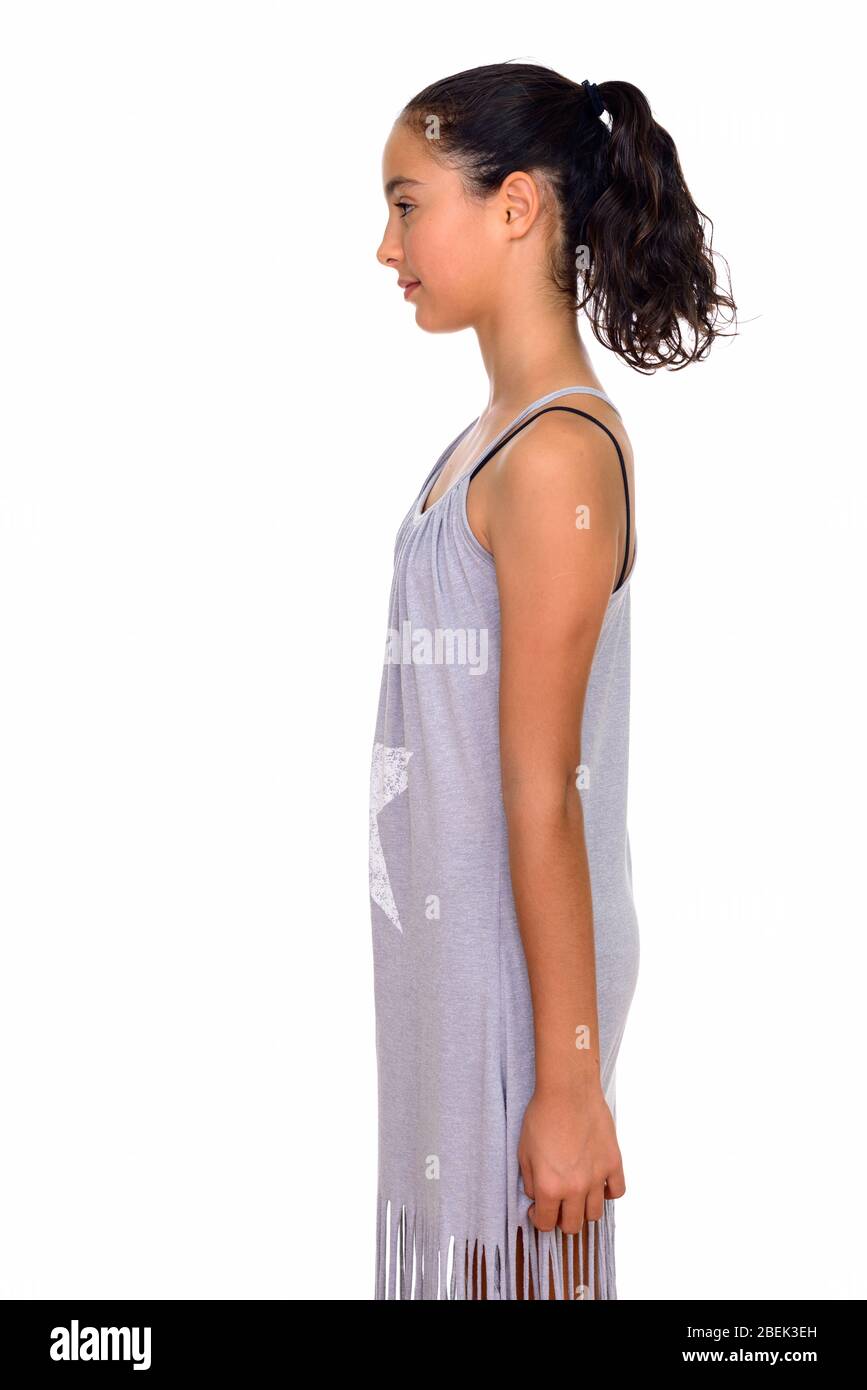 Side view of young beautiful teenage girl isolated against white ...