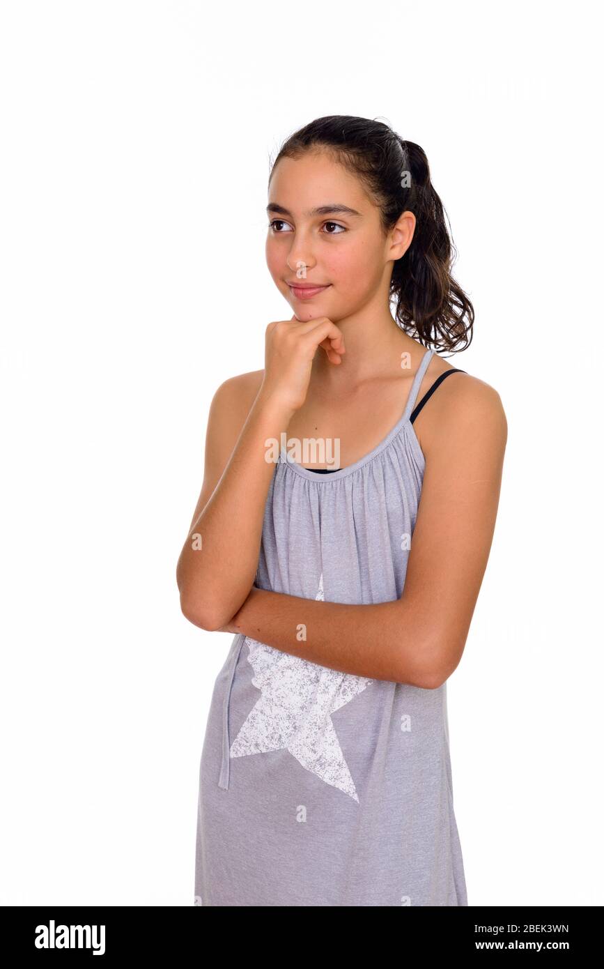 Studio shot of young beautiful teenage girl thinking isolated against ...