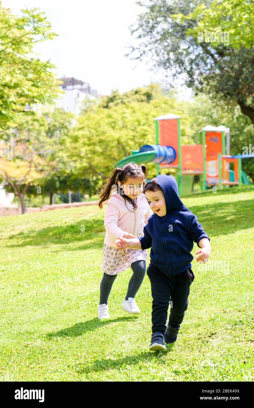 Children running. Happy lovely little siblings running, chasing and ...