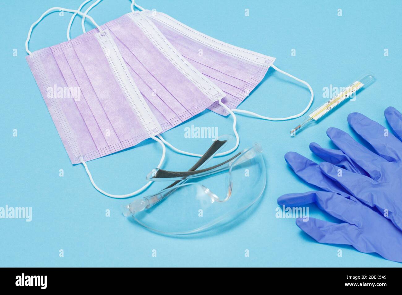 Latex gloves, medical masks, a glass mercury thermometer and safety ...