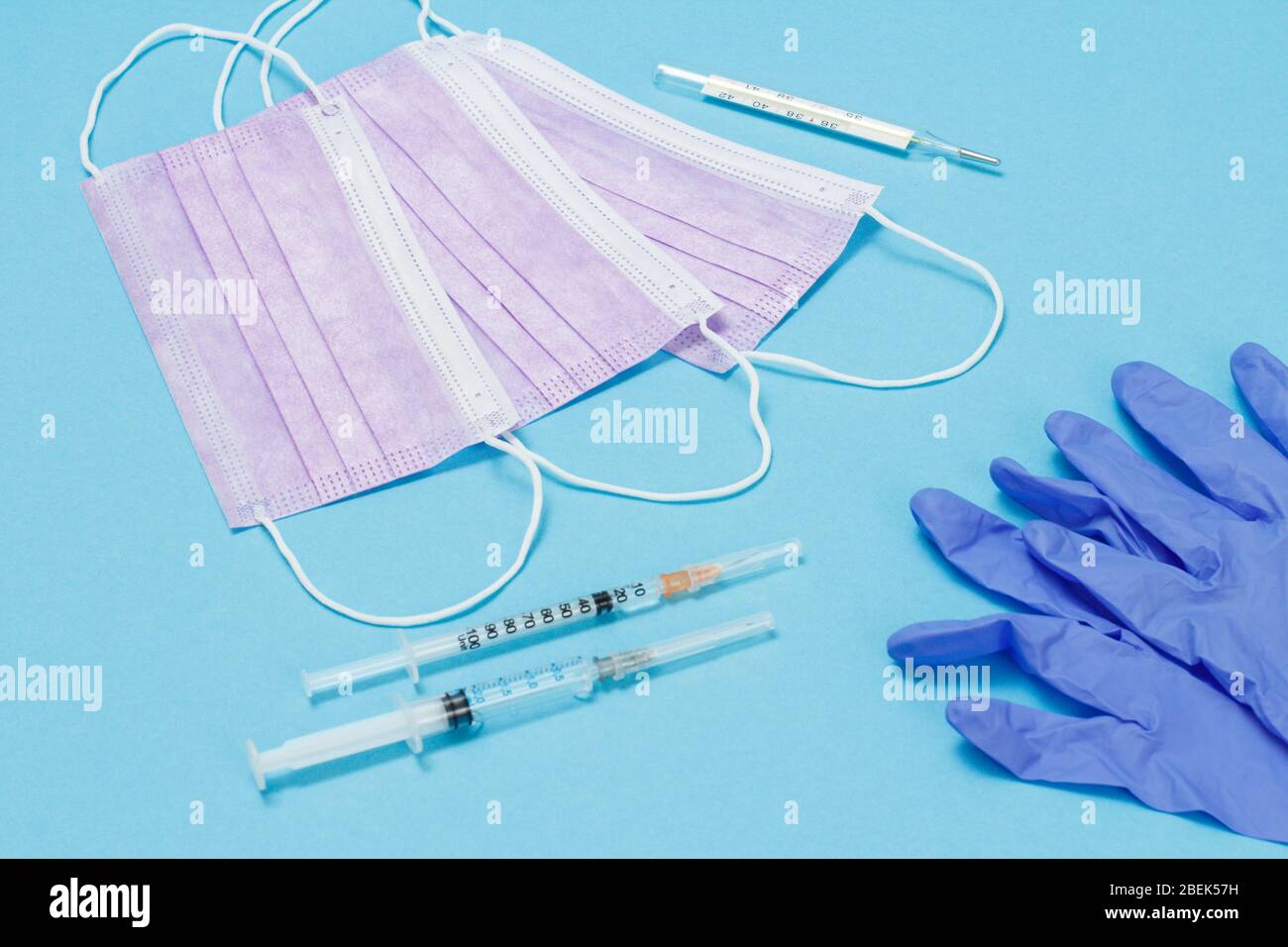 Latex gloves, medical masks, syringes for injection and a glass mercury ...
