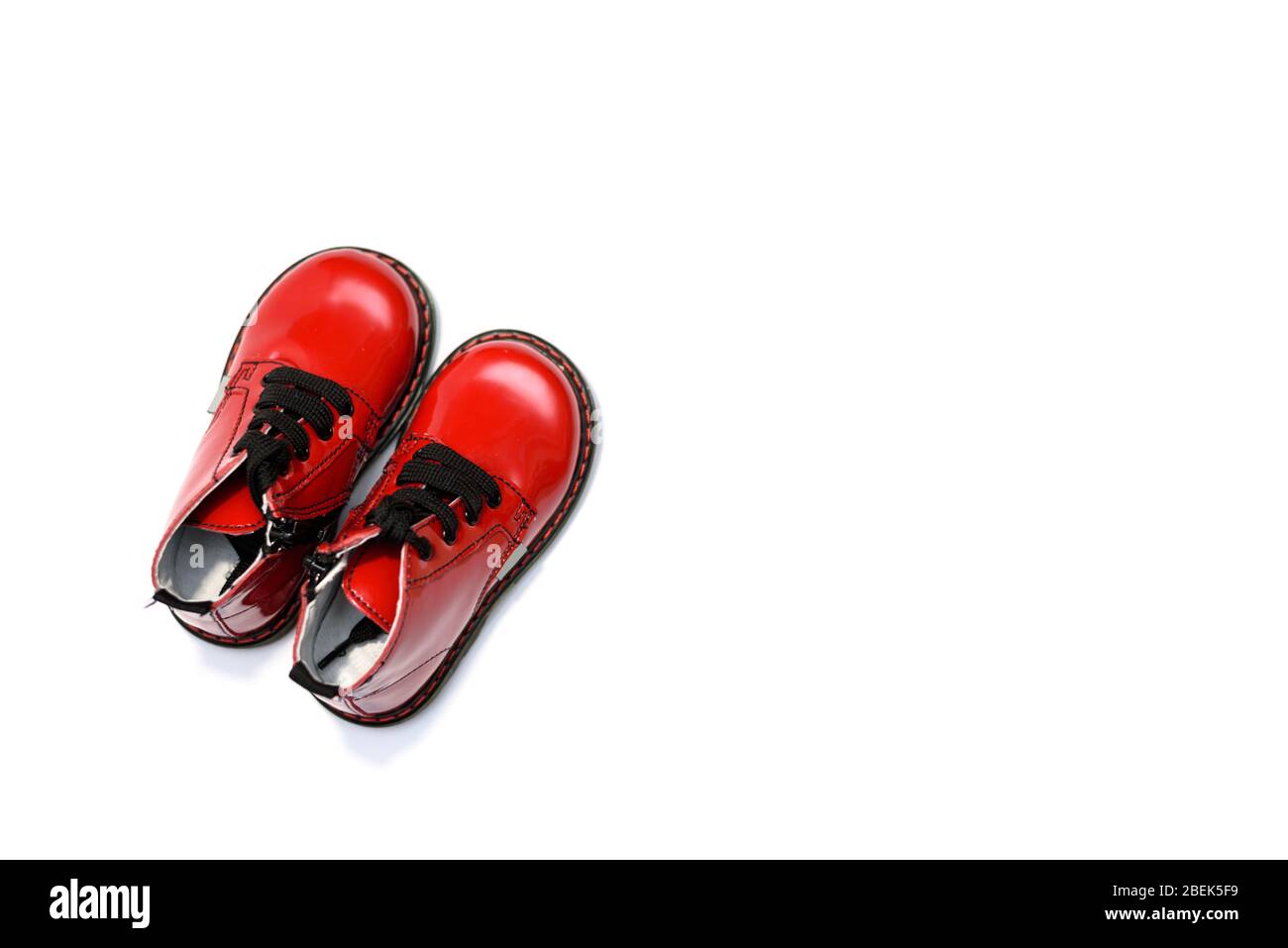 Children's beautiful shiny red boots isolated on the white background ...