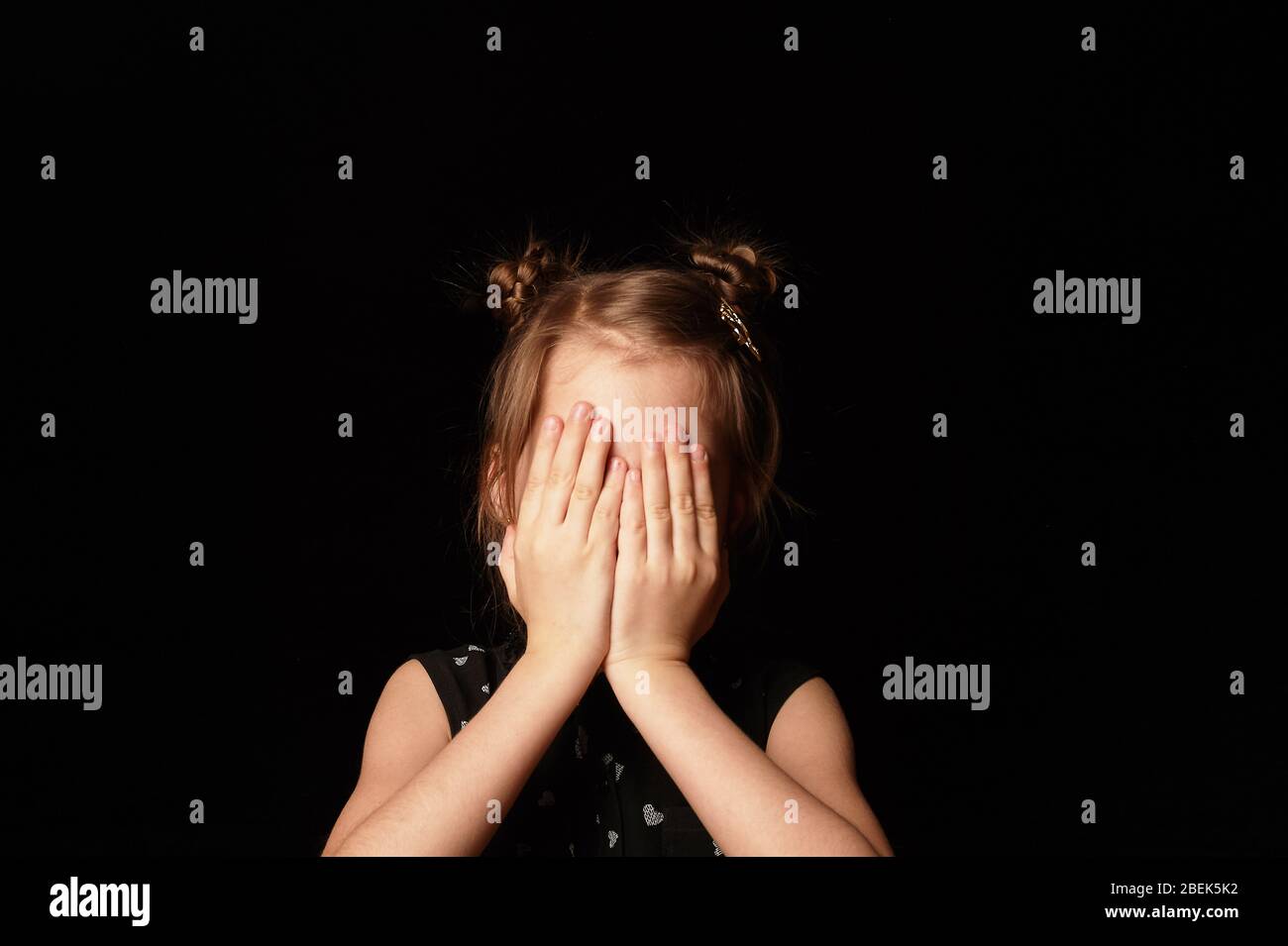 The girl is 6 years old.The face is covered with his hands. Solitude ...