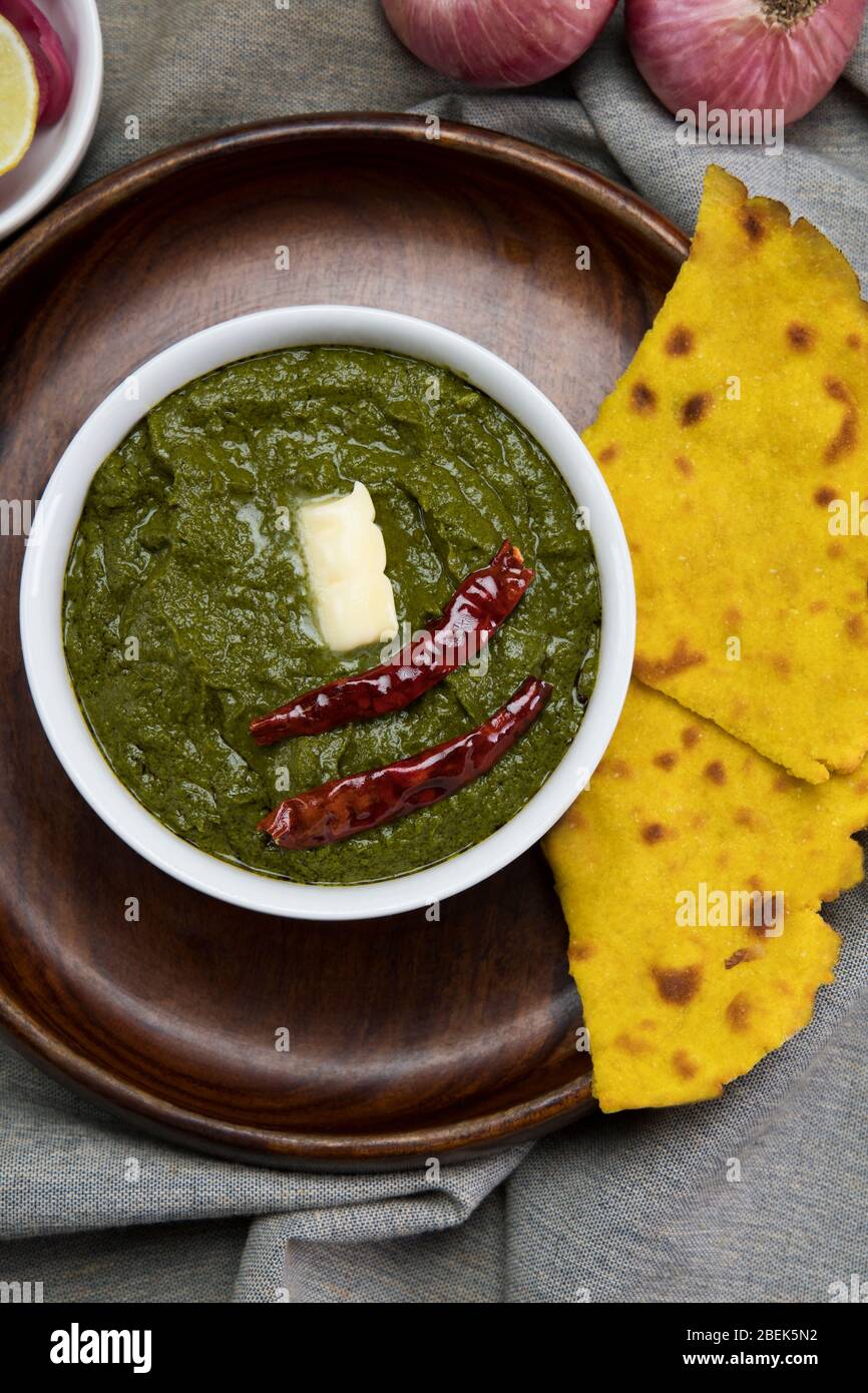 Mouth watering bowl of sarso ka saag with makki ki roti kept on a ...