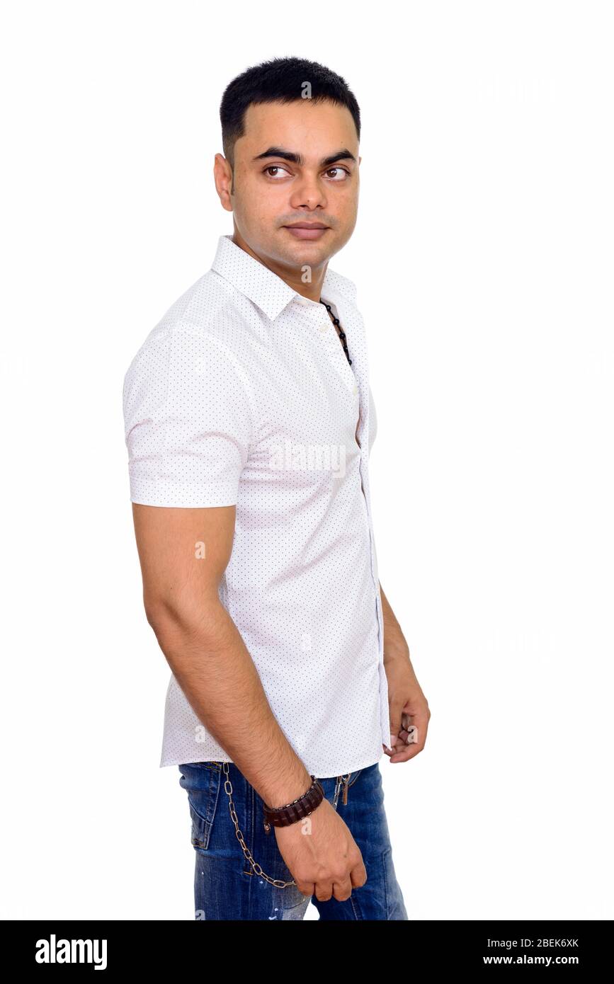 Profile view of young handsome Indian man looking over shoulder Stock ...