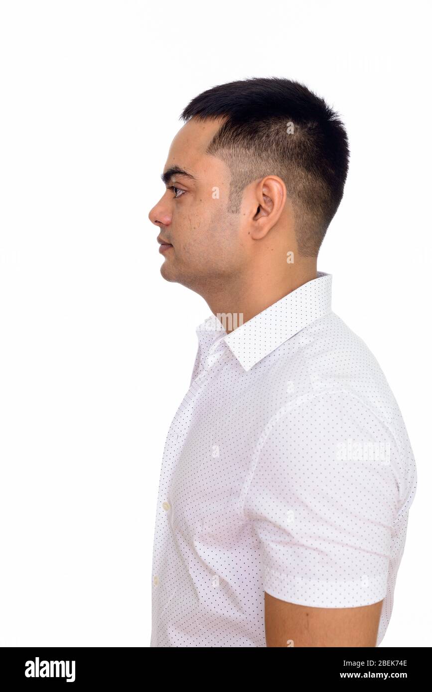 Side view of young handsome Indian man isolated against white ...