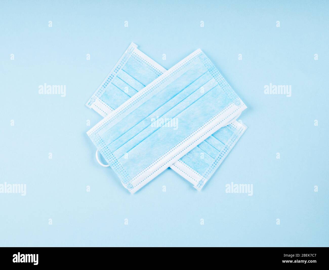 Face masks on blue as symbol of covid19 pandemic Stock Photo - Alamy