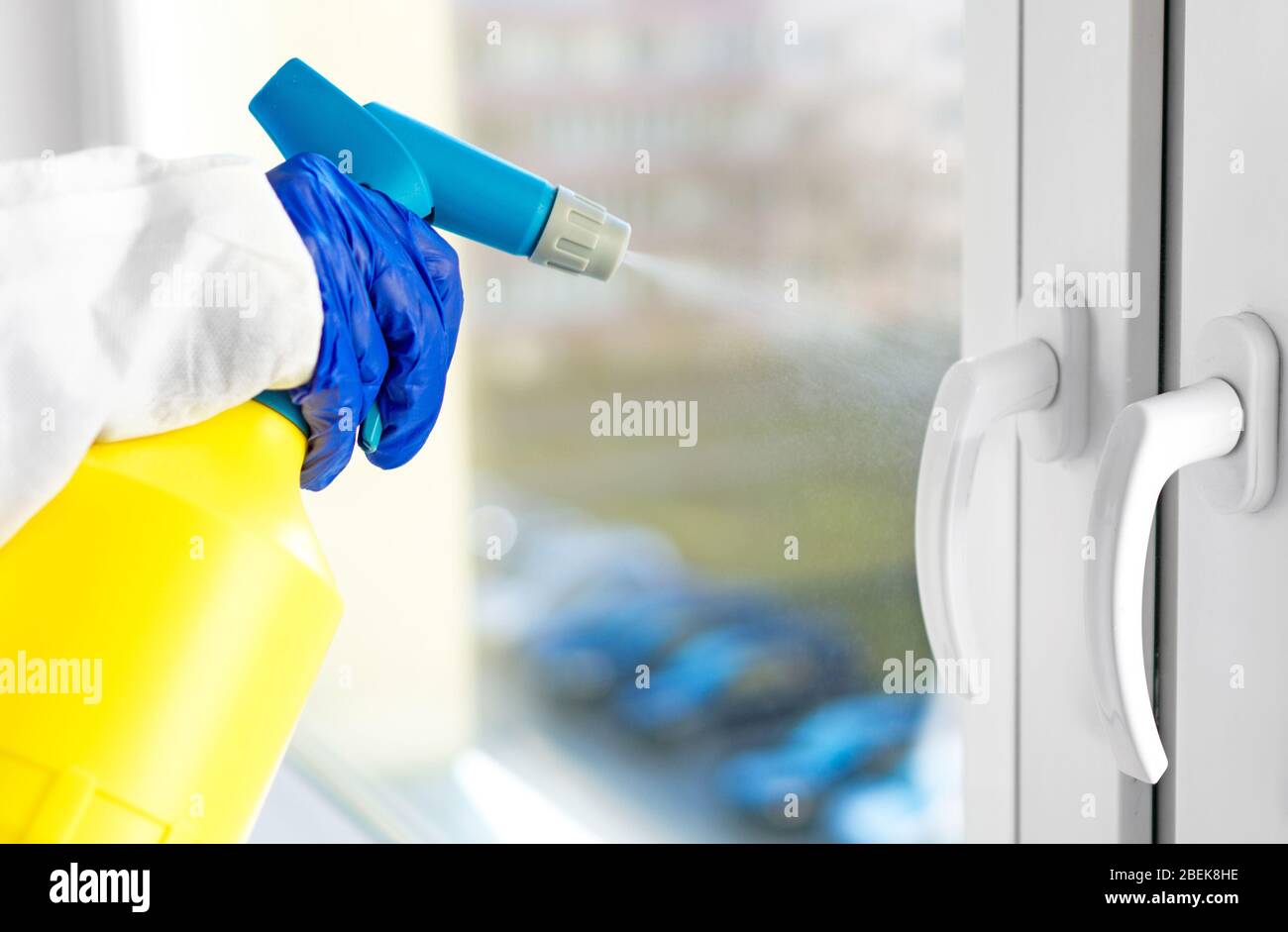 Cleaner in biohazard suit disinfecting window handles is room Stock ...