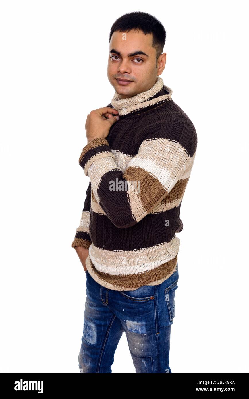 Studio shot of young handsome Indian man isolated against white ...