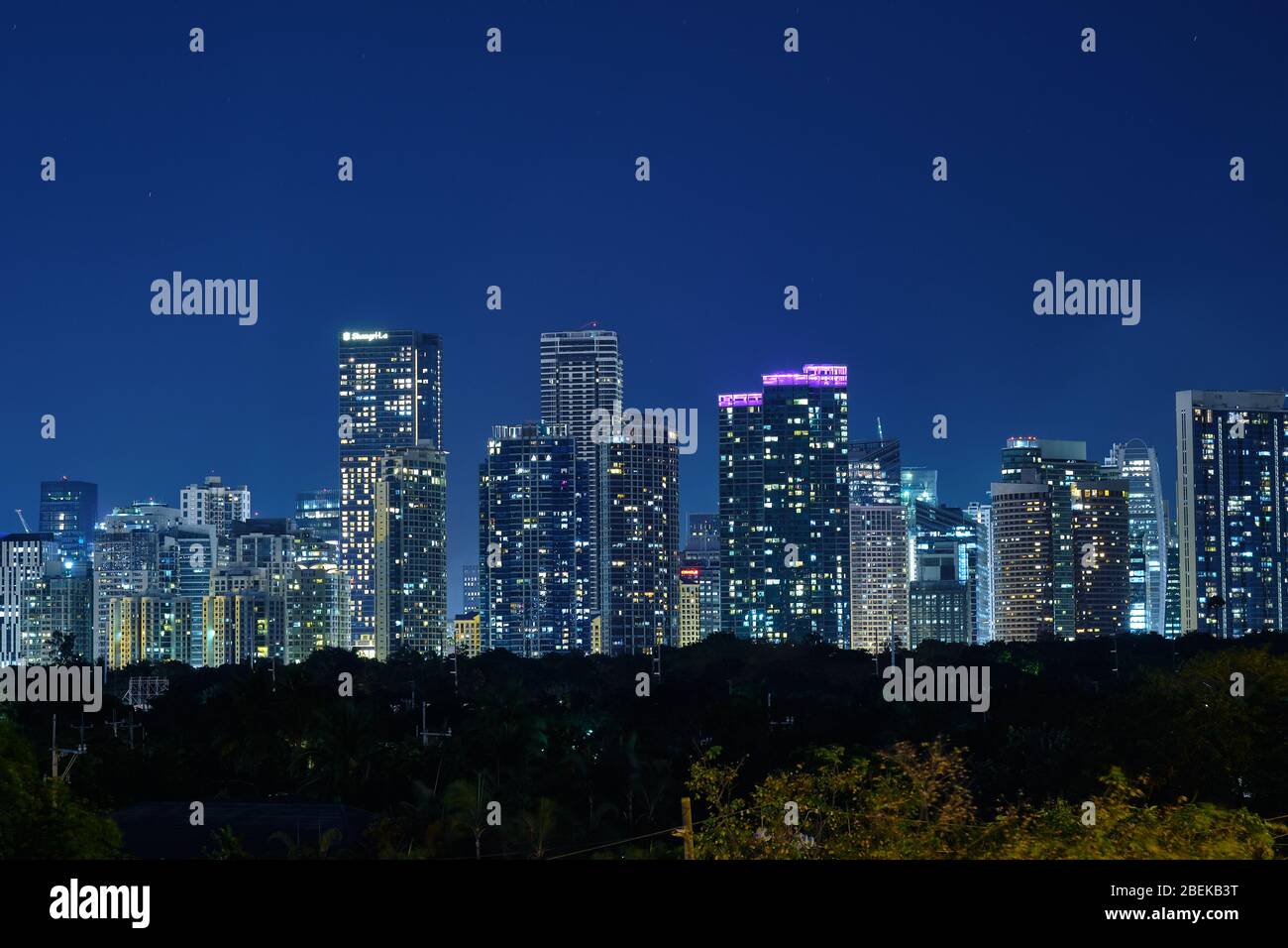 View of the night city of Manila from the pool of the luxury five-star ...