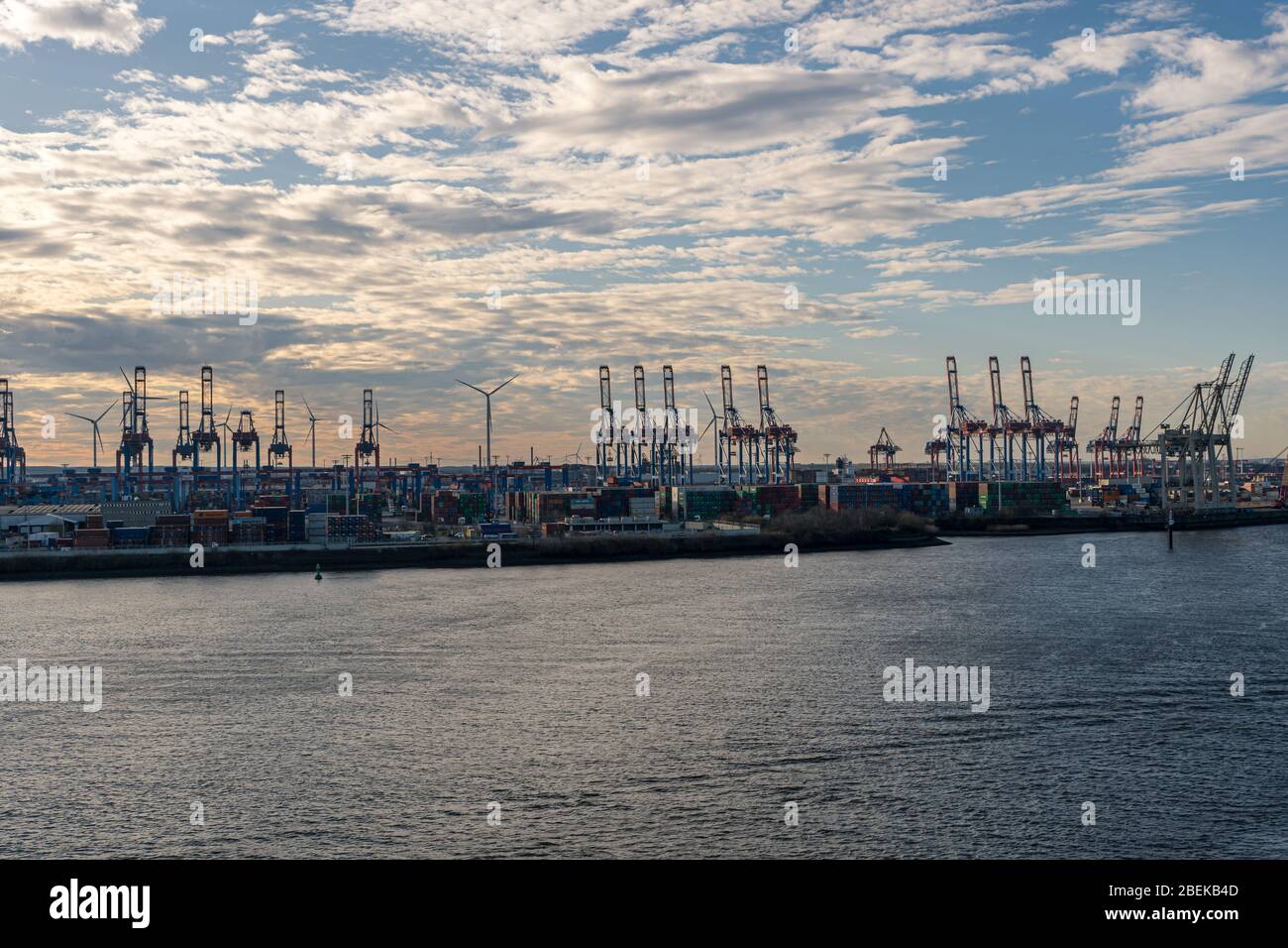 Hamburg container port with some ships loading and cranes transporting ...