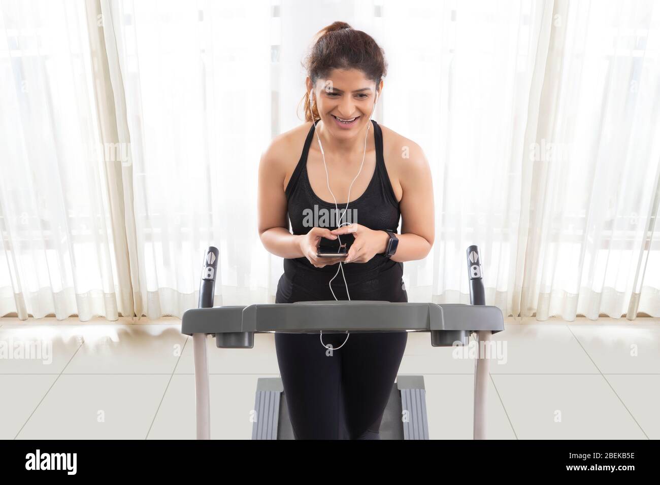 Woman exercises on treadmill home hi-res stock photography and images ...