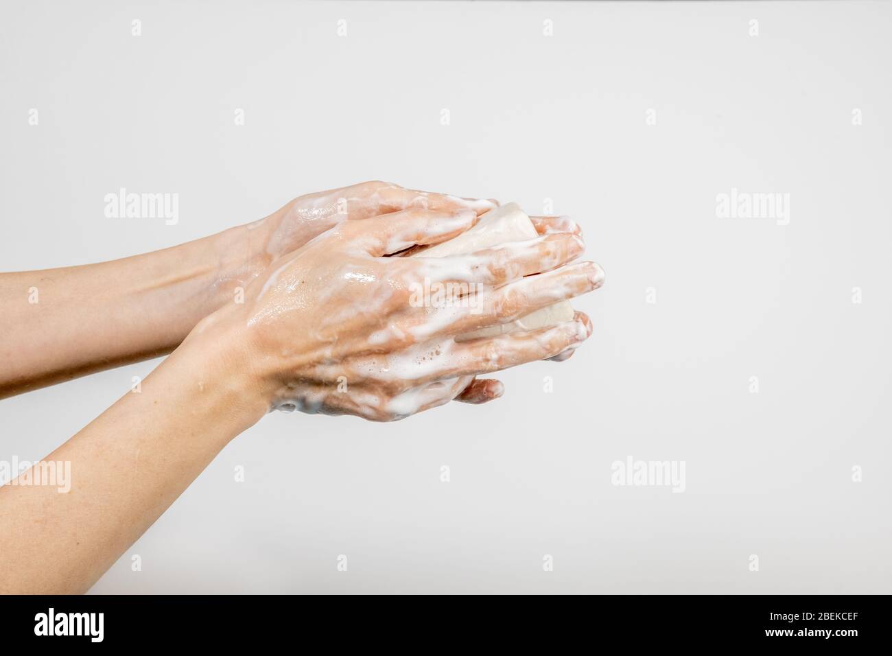 Close up of Caucasian woman washing her hands with bubbly soap bar ...