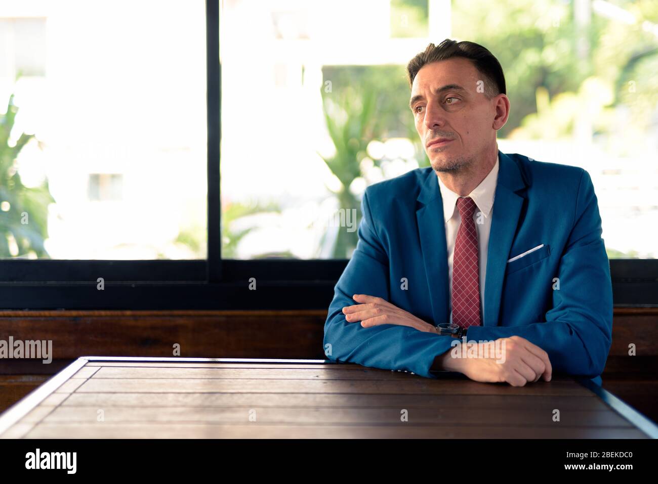 Mature handsome Italian businessman relaxing at the coffee shop Stock ...