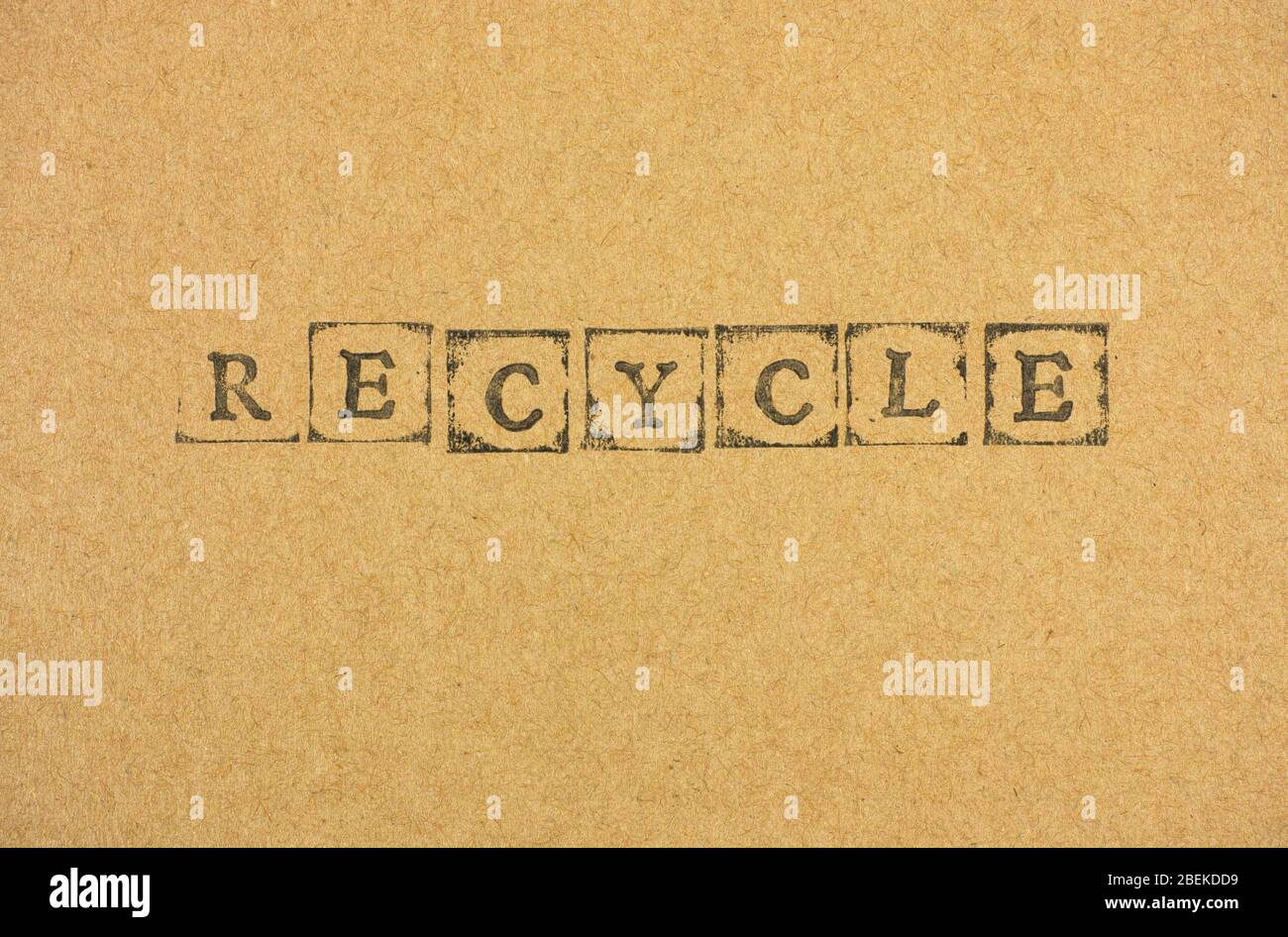 Cardboard with word Recycle made by black alphabet stamps Stock Photo ...