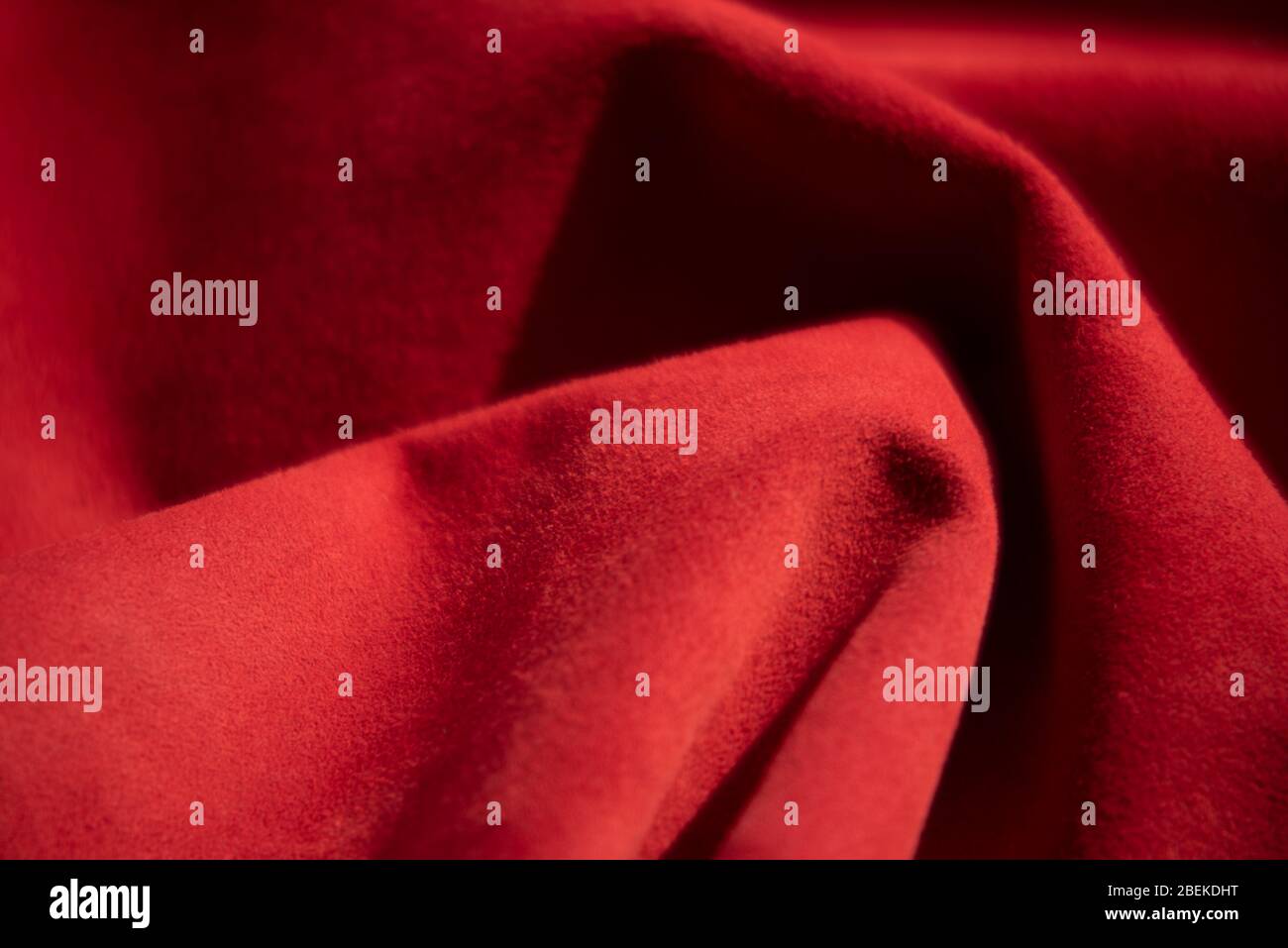 Red matte background of suede fabric, closeup. Velvet texture of ...