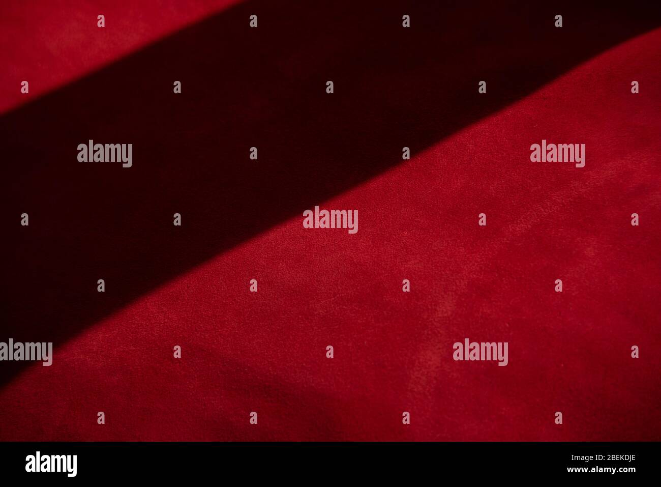 Red matte background of suede fabric, closeup. Velvet texture of ...