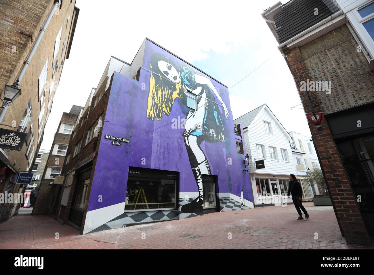 Brighton, UK. 14th Apr, 2020. A person walks past a giant mural of ...