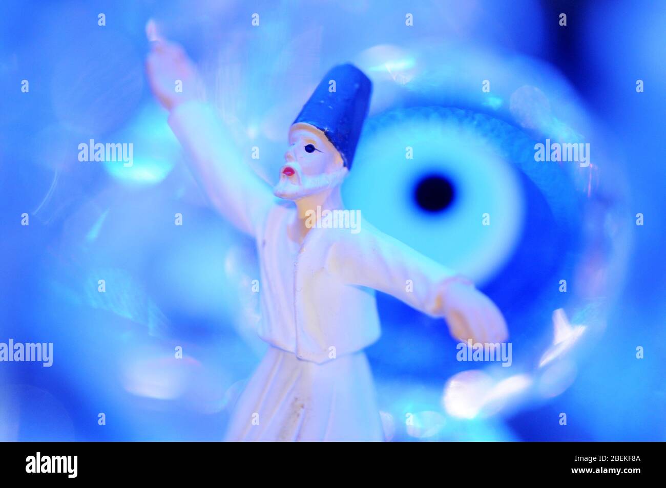 The little figure of dancing dervish on blue background Stock Photo - Alamy