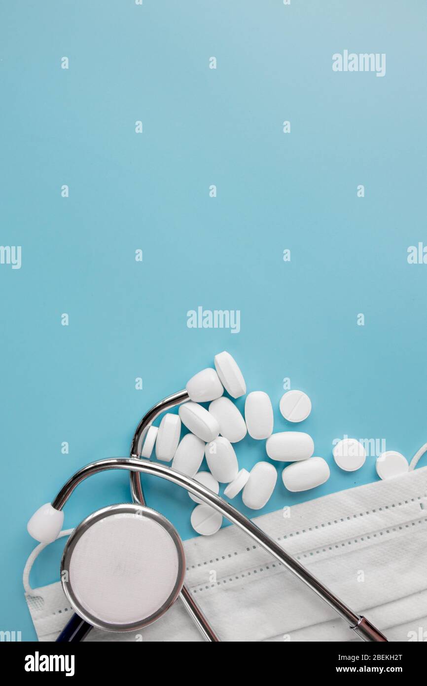 Composition with medical stethoscope, disposable face masks pills on a ...