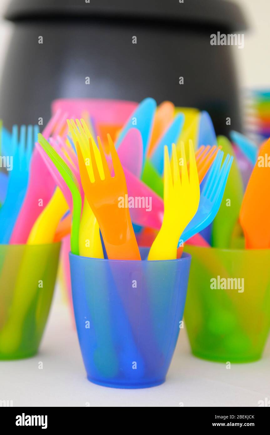 The colorful plastic cutlery in colorful plastic cups Stock Photo - Alamy