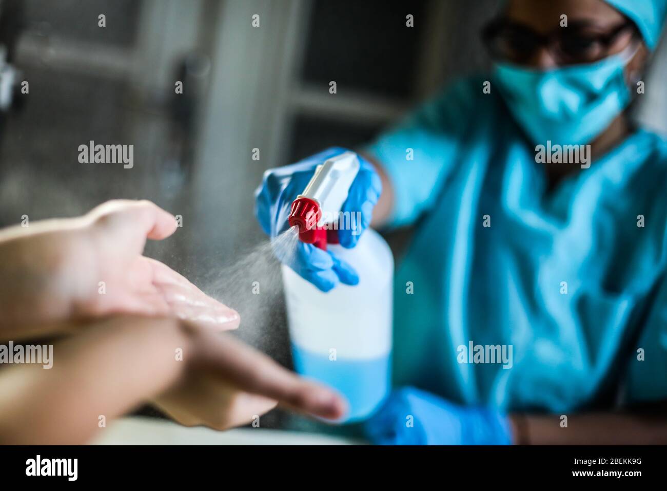 Doctor spray disinfectant on hands hi-res stock photography and images ...