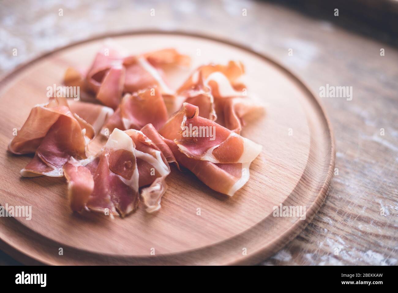 Spanish jamon on a wooden plate. Board with flour Stock Photo - Alamy