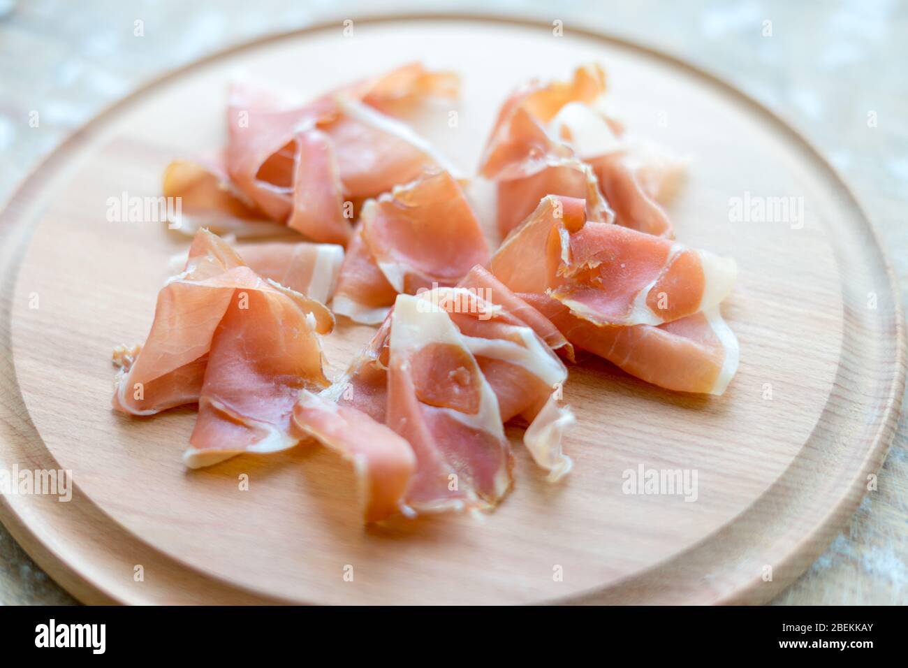 Spanish jamon on a wooden plate. Board with flour Stock Photo - Alamy