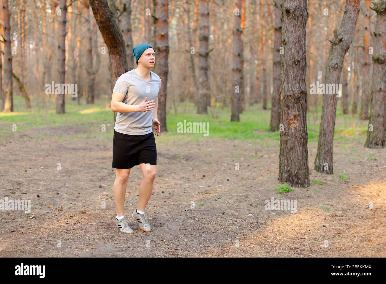 Young man jogging and running in morning park Stock Photo - Alamy