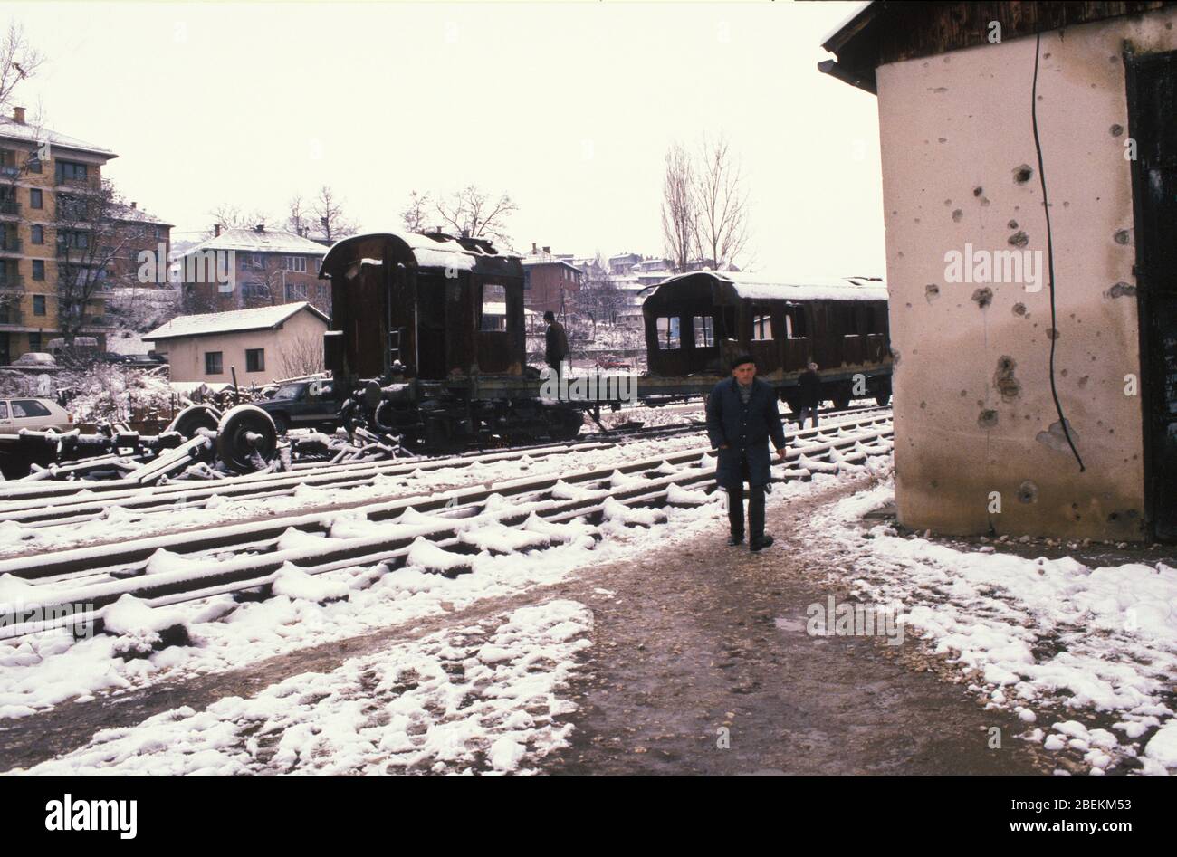 Sarajevo 1995 - people walking past war damaged trains in central ...