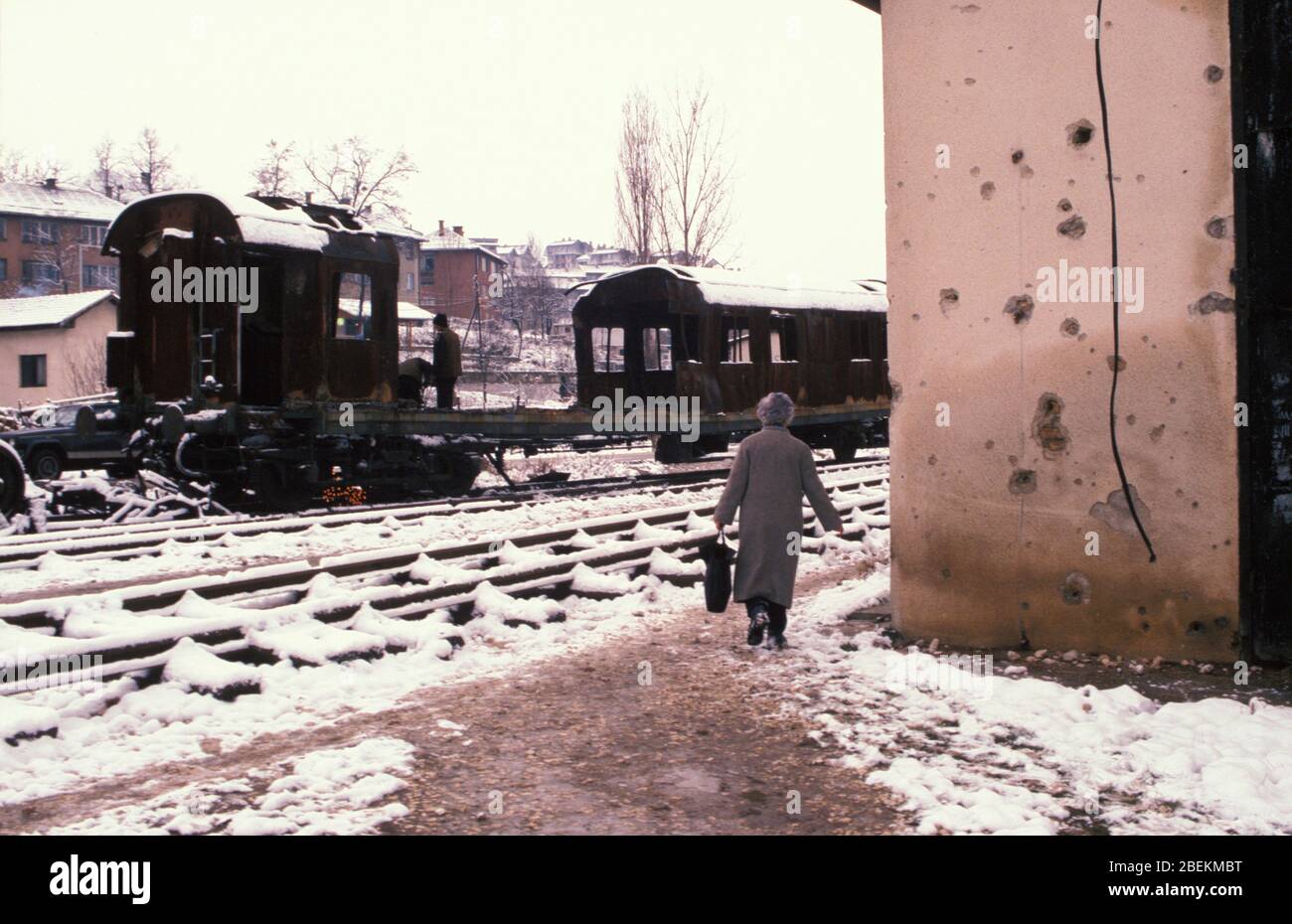 Sarajevo 1995 - people walking past war damaged trains in central ...